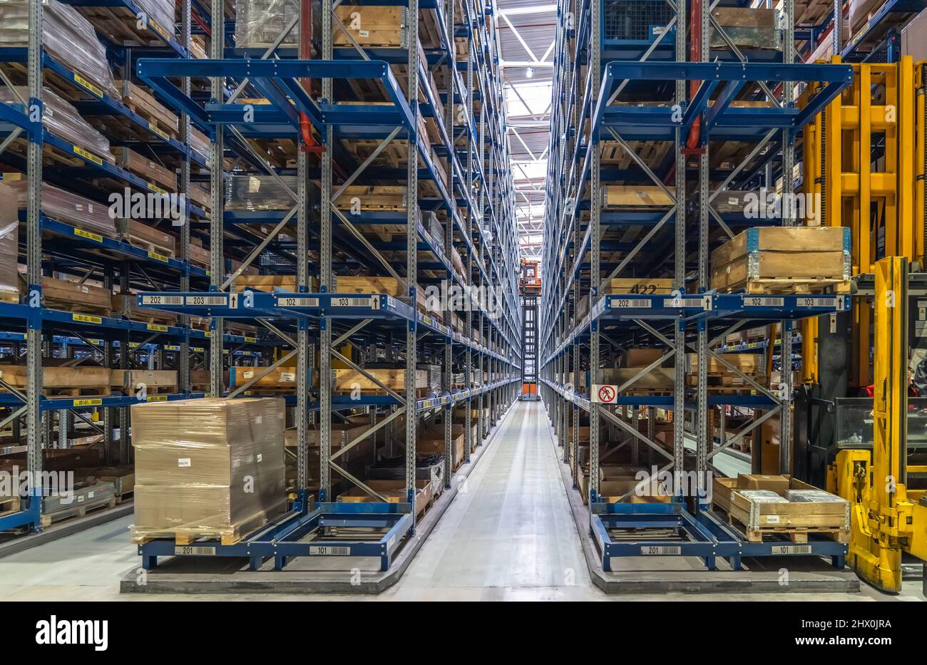 Cargo warehouse or storehouse with many shelves. Goods distribution ...