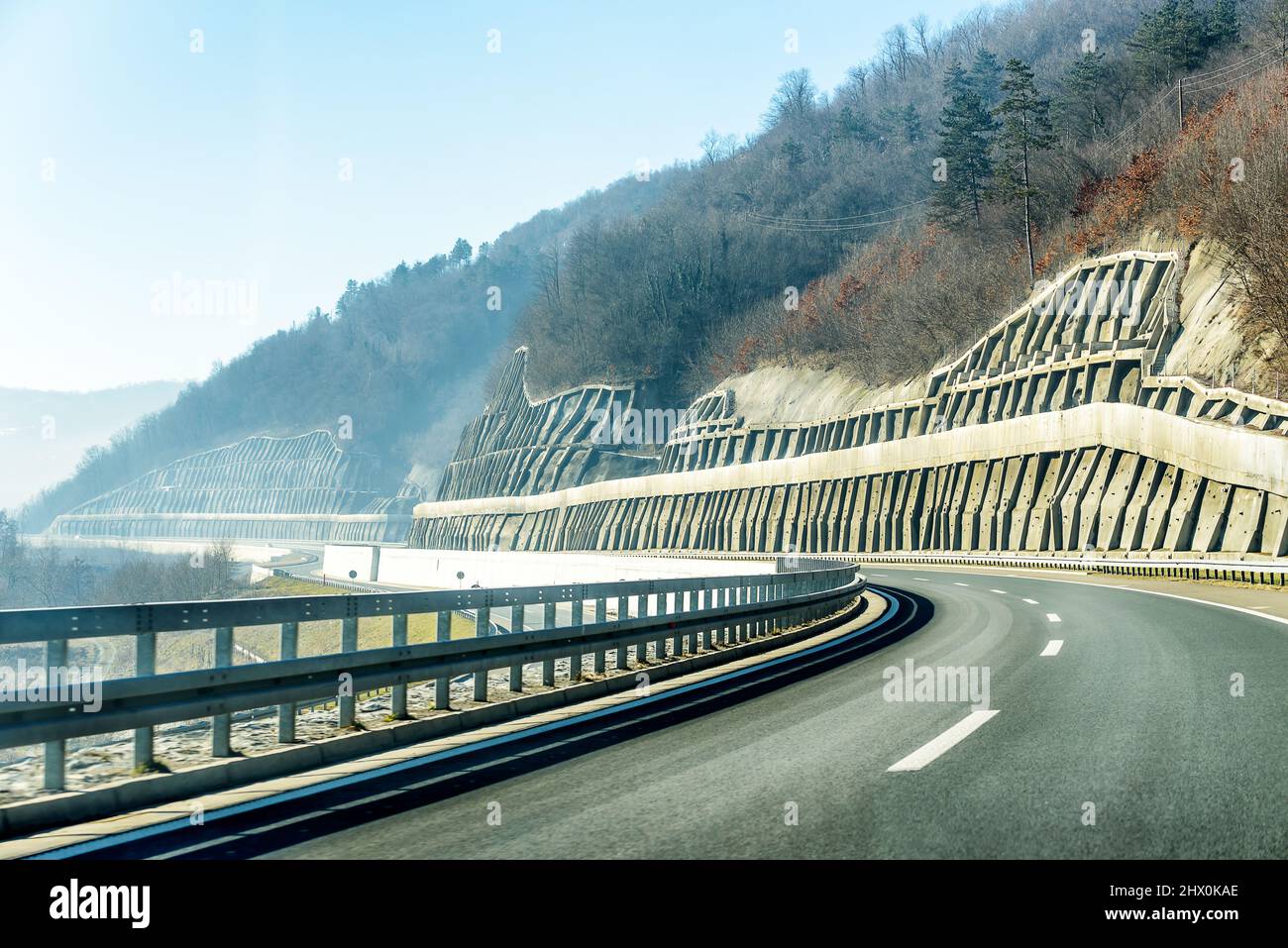Highway with road slope erosion protection on the hillside Stock Photo ...