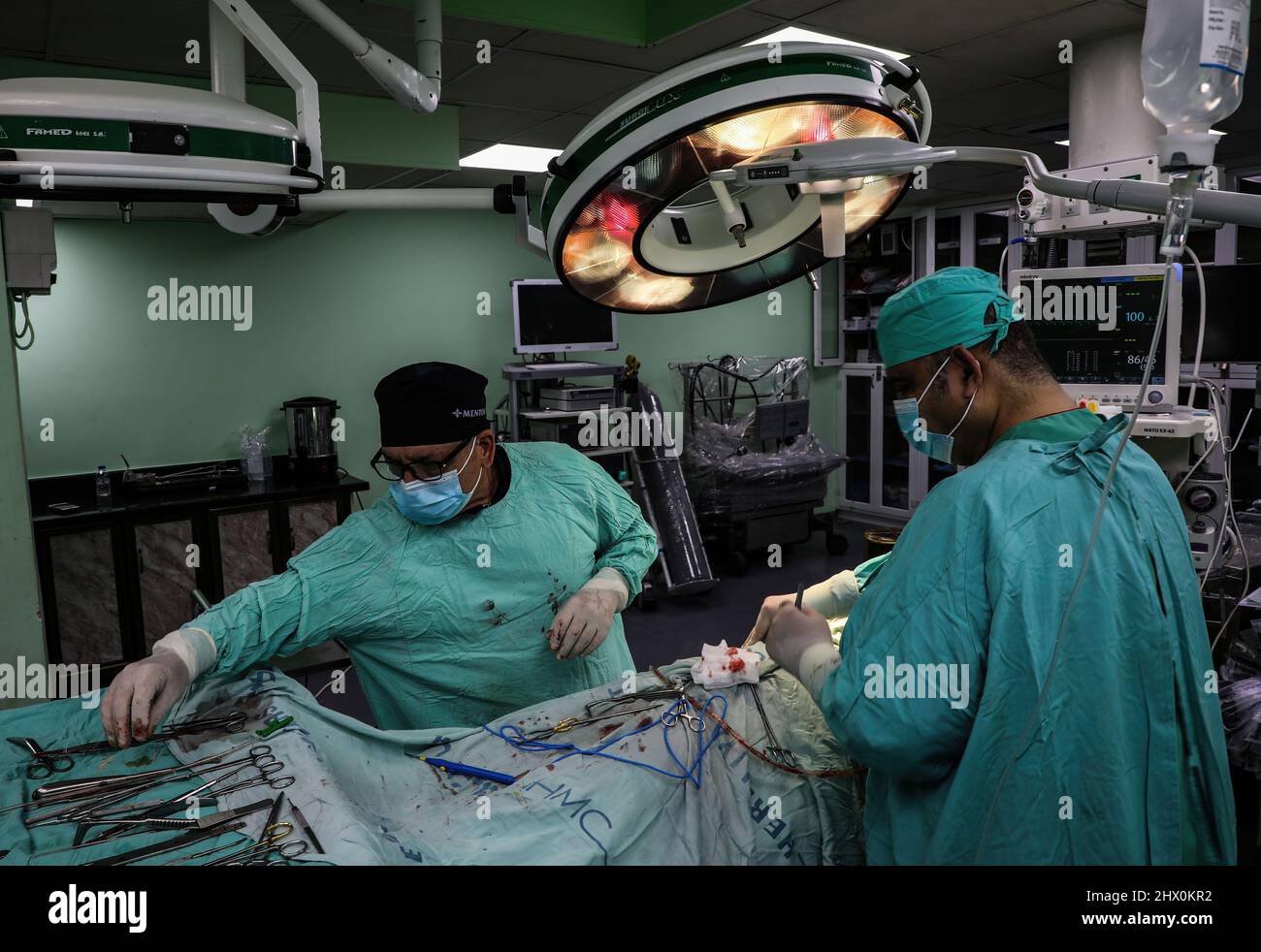 Palestinian doctors in the Gaza Strip perform a plastic surgery on a ...