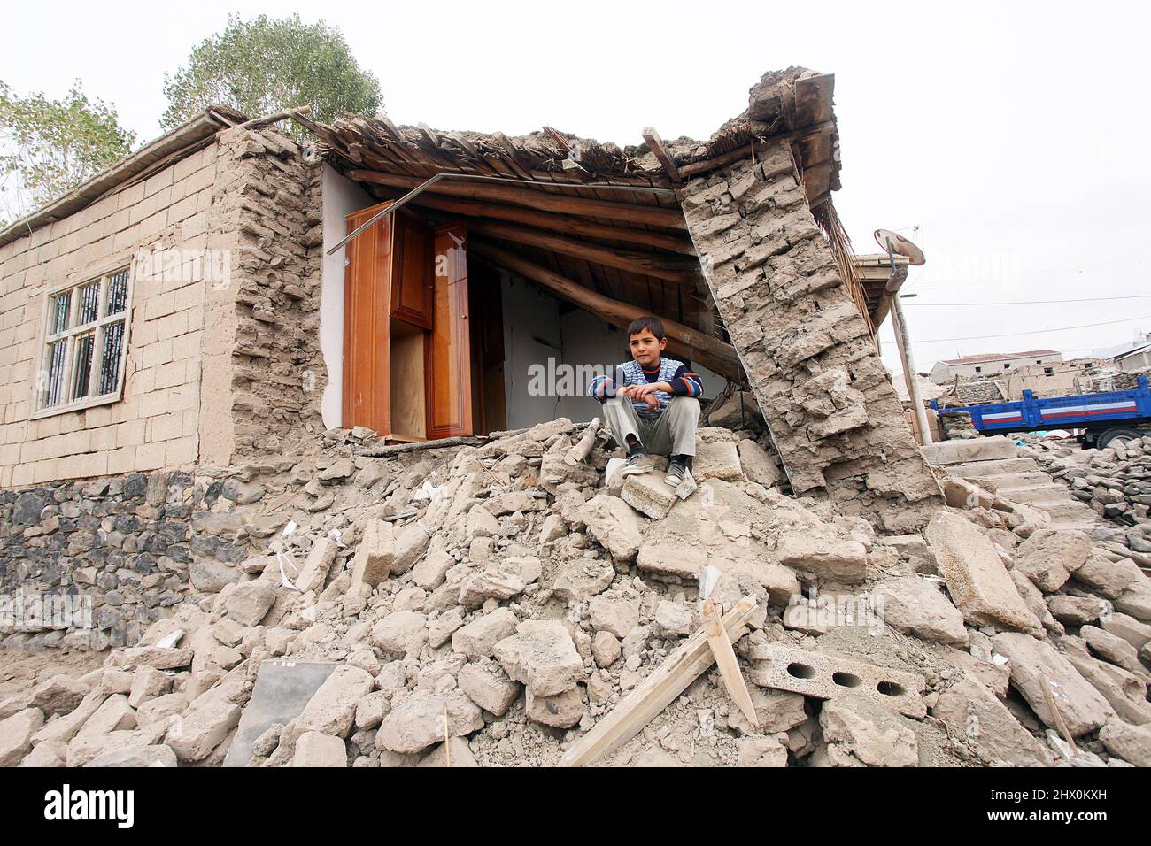 VAN, TURKEY - OCTOBER 25: Earthquake victim child in front of the their ...