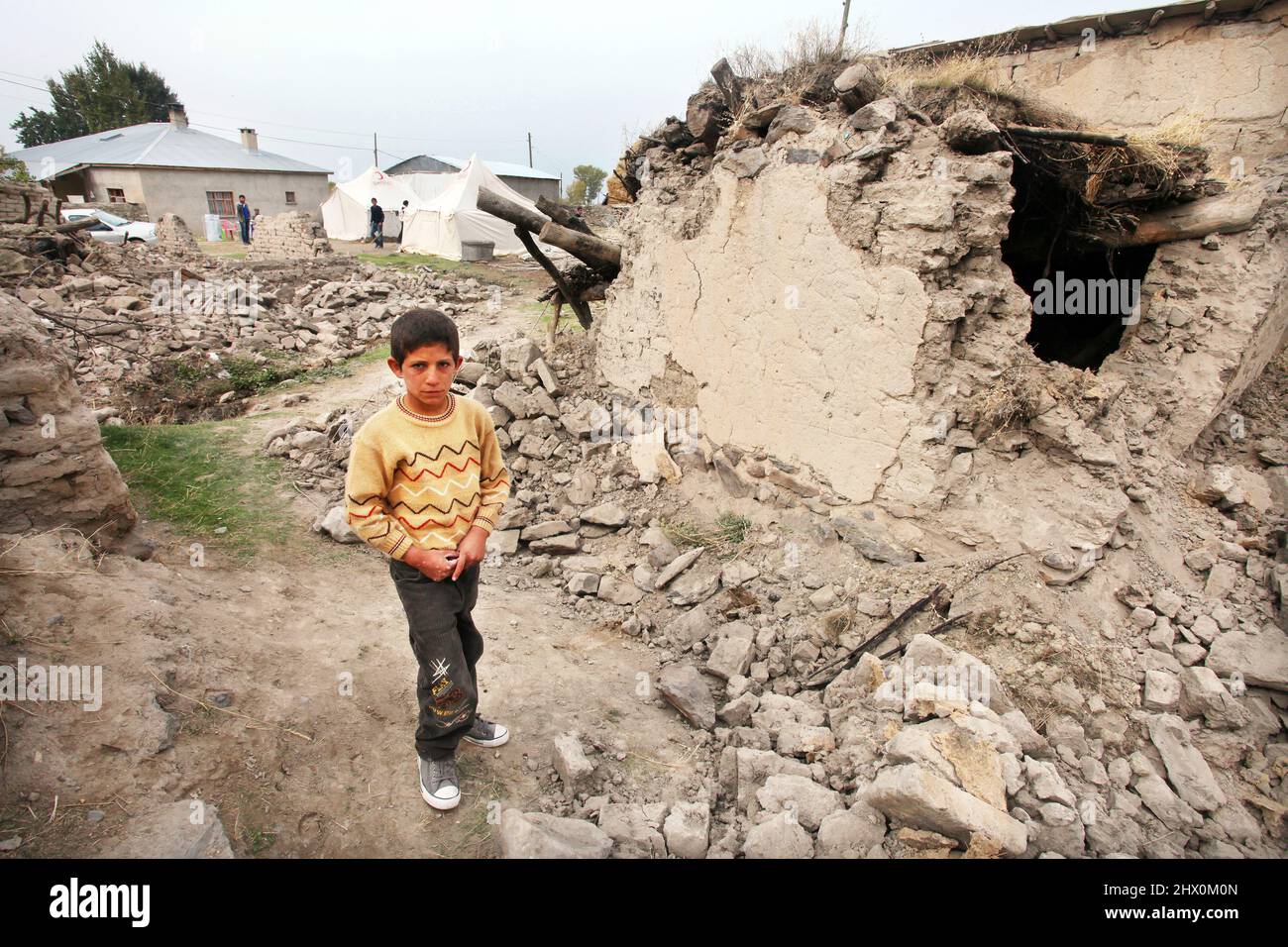 VAN, TURKEY - OCTOBER 25: Earthquake victim child in front of the their ...