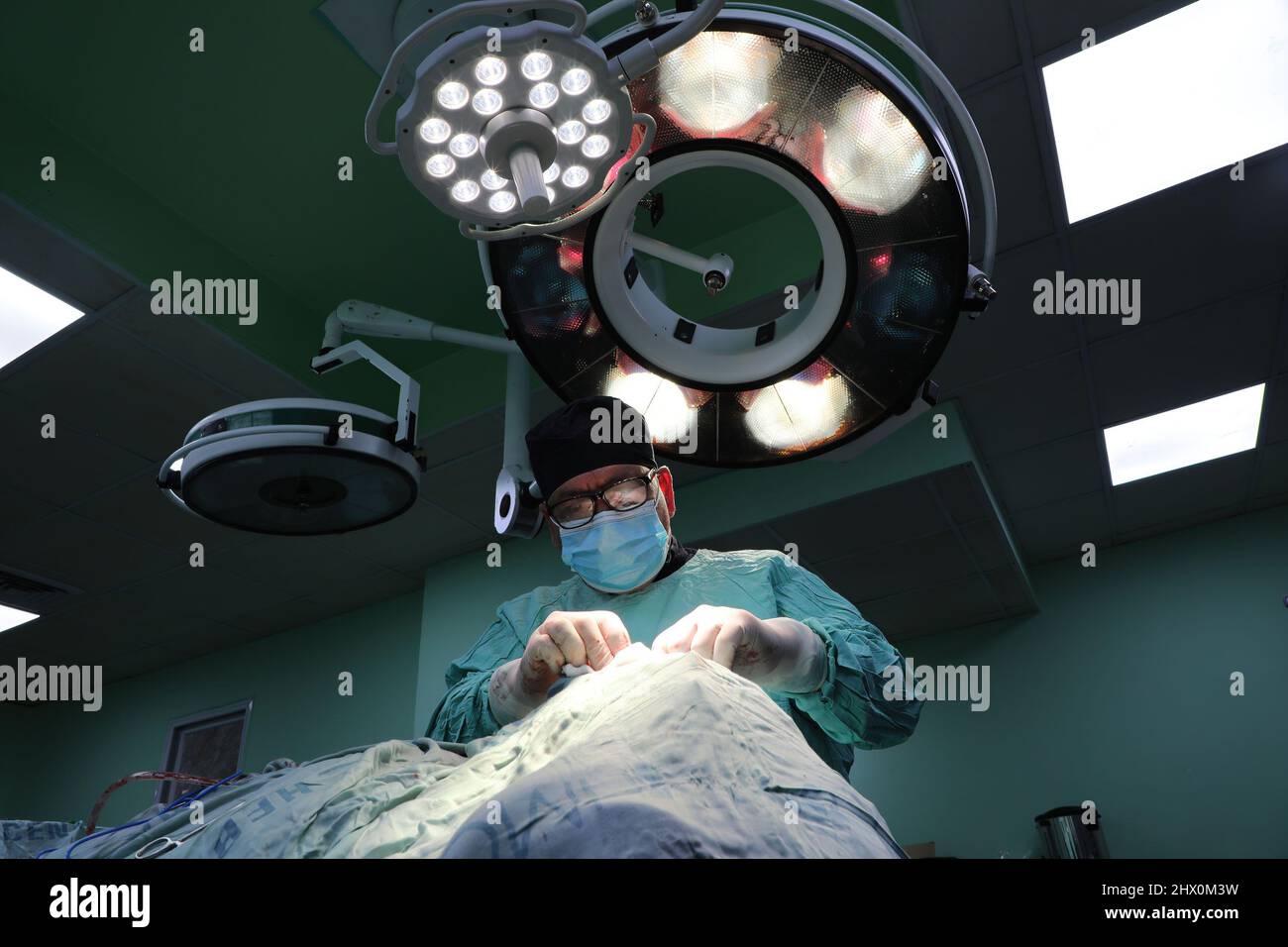 A Palestinian doctor in the Gaza Strip performs a plastic surgery on a ...