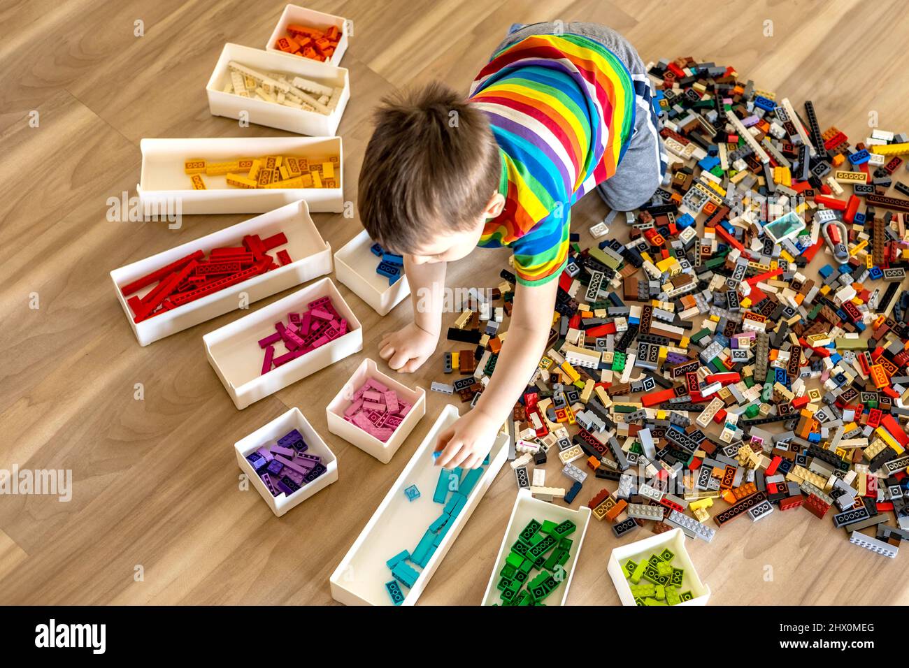 Khabarovsk, Russia, February 25, 2022. Cute baby boy sorting Lego ...