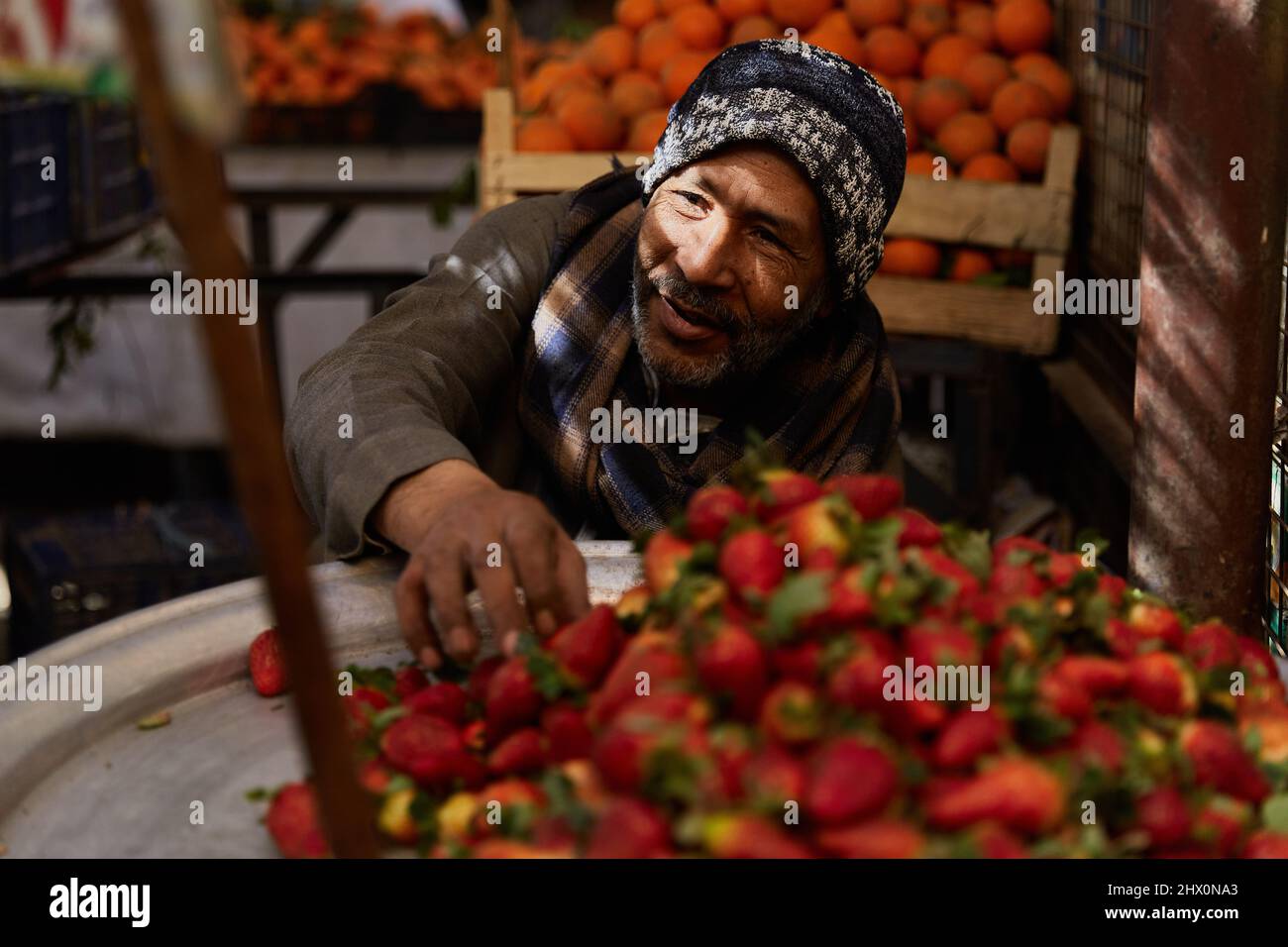 HURGHADA, EGYPT - FEBRUARY 20, 2022: Local seller sitting in the market ...