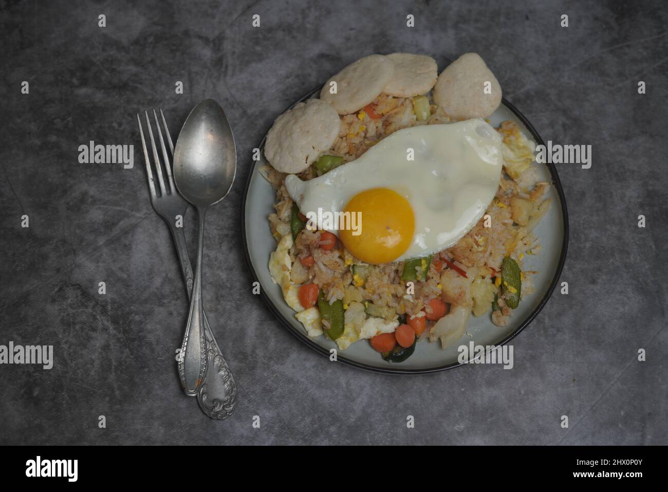 Nasi Goreng/Fried Rice served with fried egg Stock Photo - Alamy
