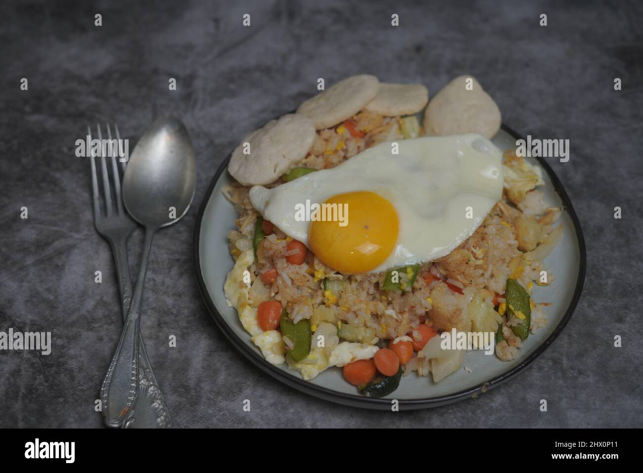 Nasi Goreng/Fried Rice served with fried egg Stock Photo - Alamy