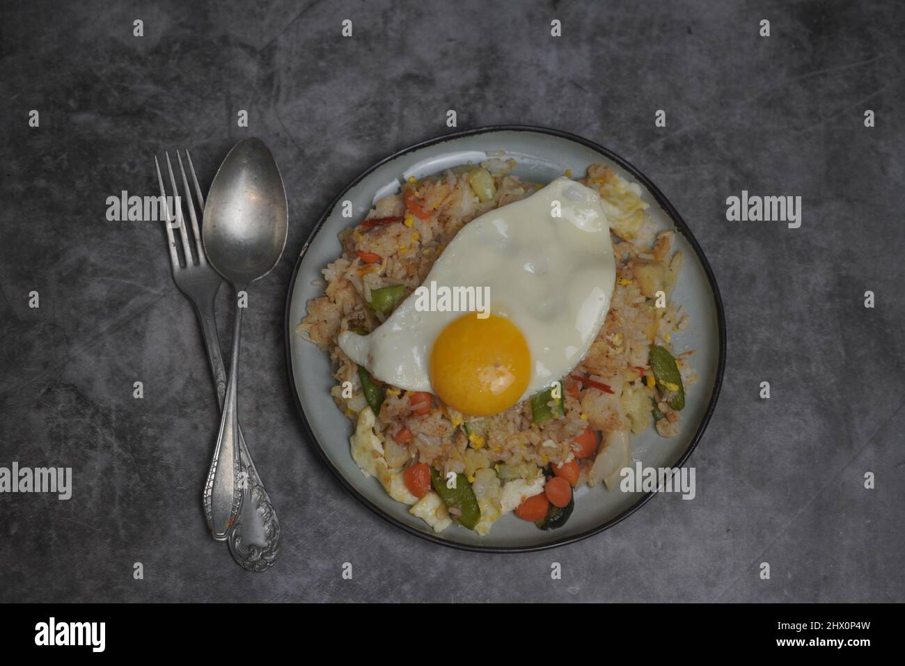 Nasi Goreng/Fried Rice served with fried egg Stock Photo - Alamy