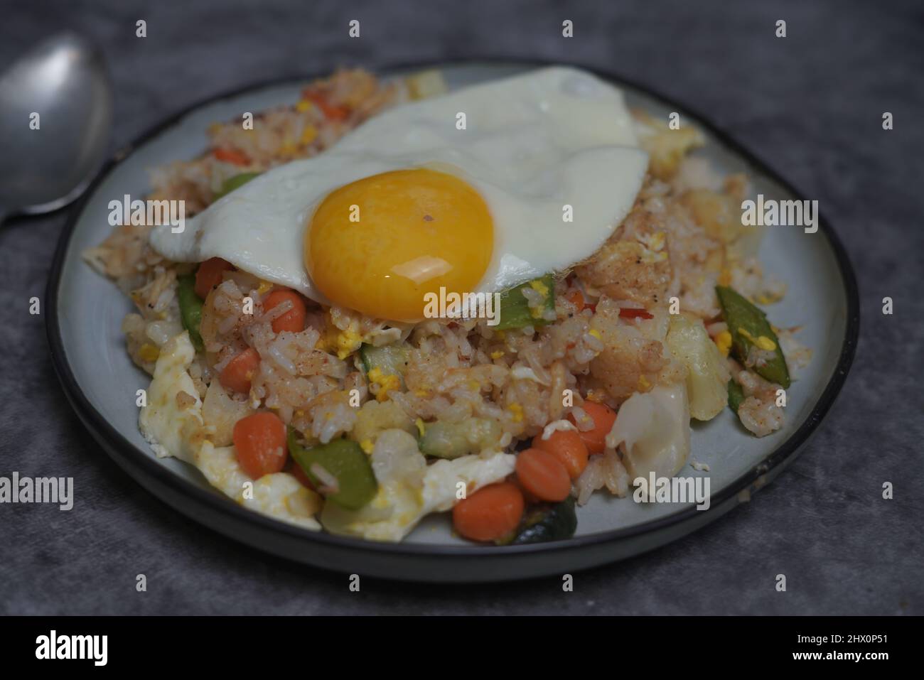 Nasi Goreng/Fried Rice served with fried egg Stock Photo - Alamy