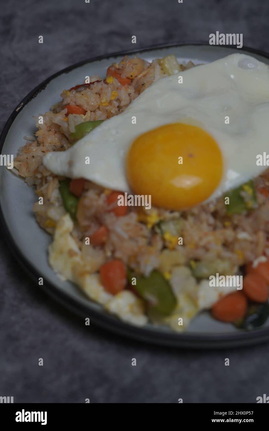 Nasi Goreng/Fried Rice served with fried egg Stock Photo - Alamy