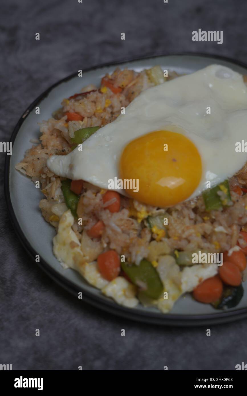 Nasi Goreng/Fried Rice served with fried egg Stock Photo - Alamy