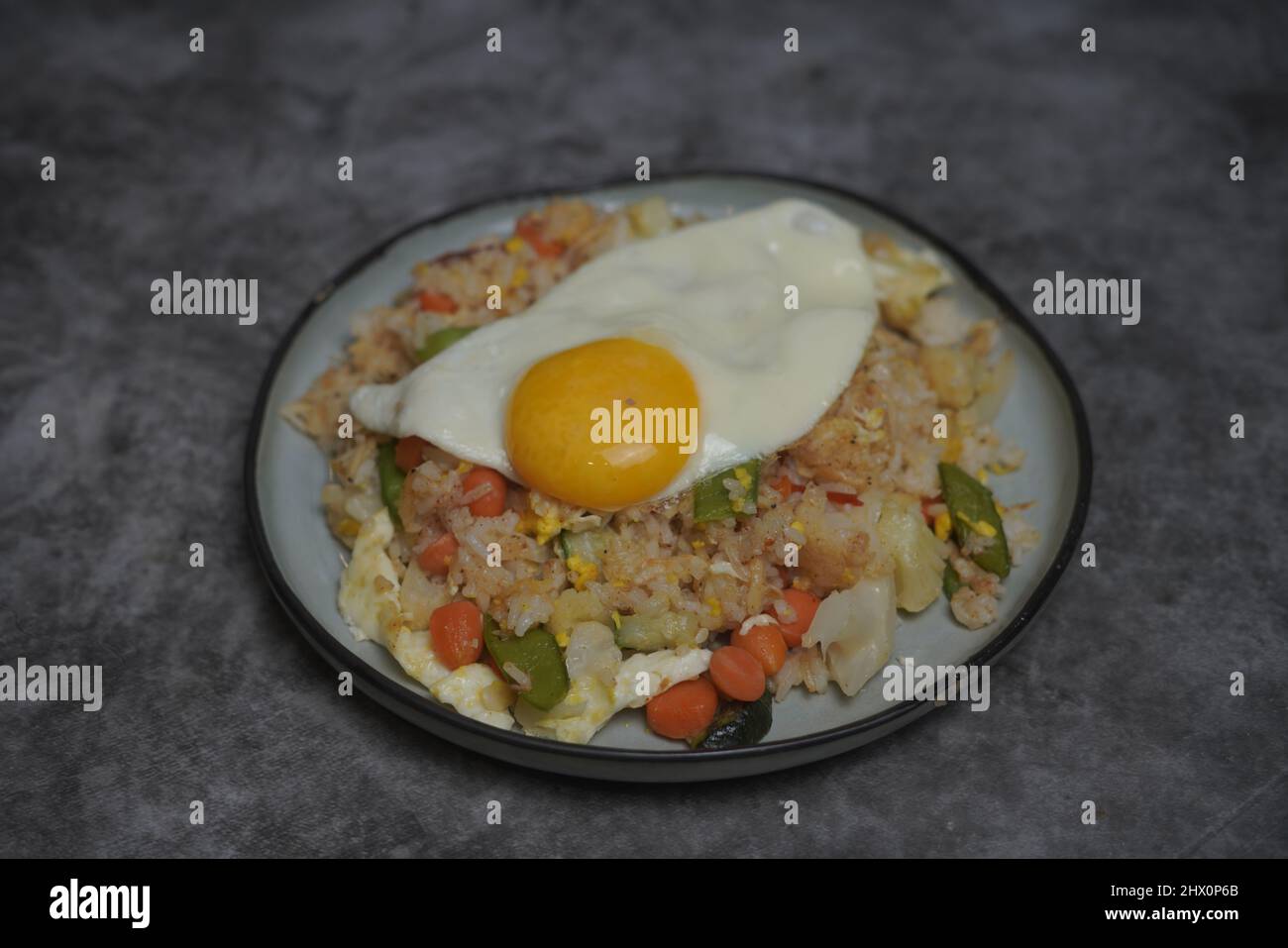 Nasi Goreng/Fried Rice served with fried egg Stock Photo - Alamy
