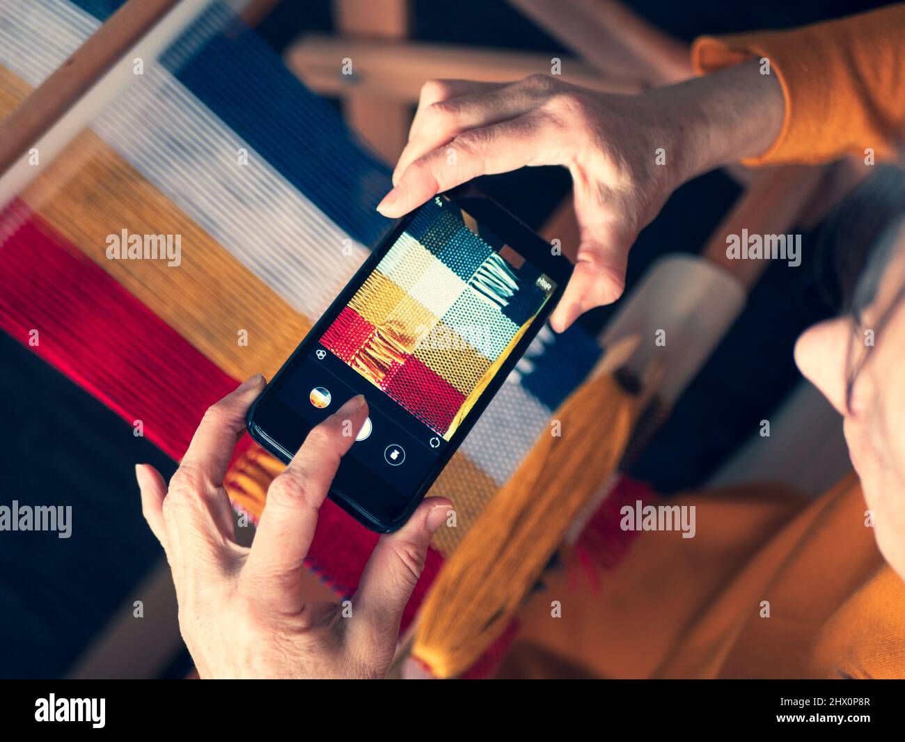 Artisan holding device and making picture of her weaving product for ...