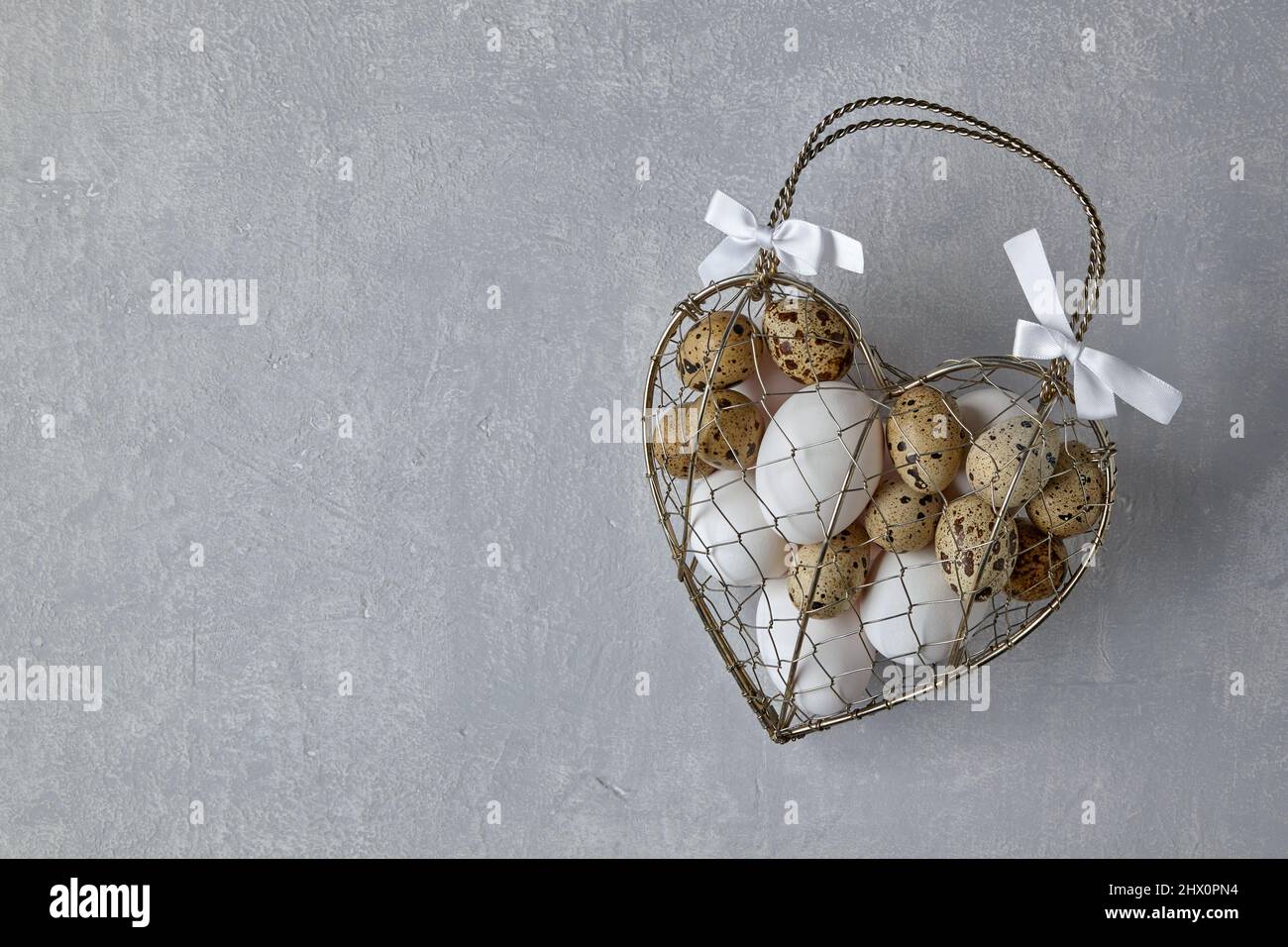 Chicken and quail eggs in a heart shaped box Stock Photo - Alamy