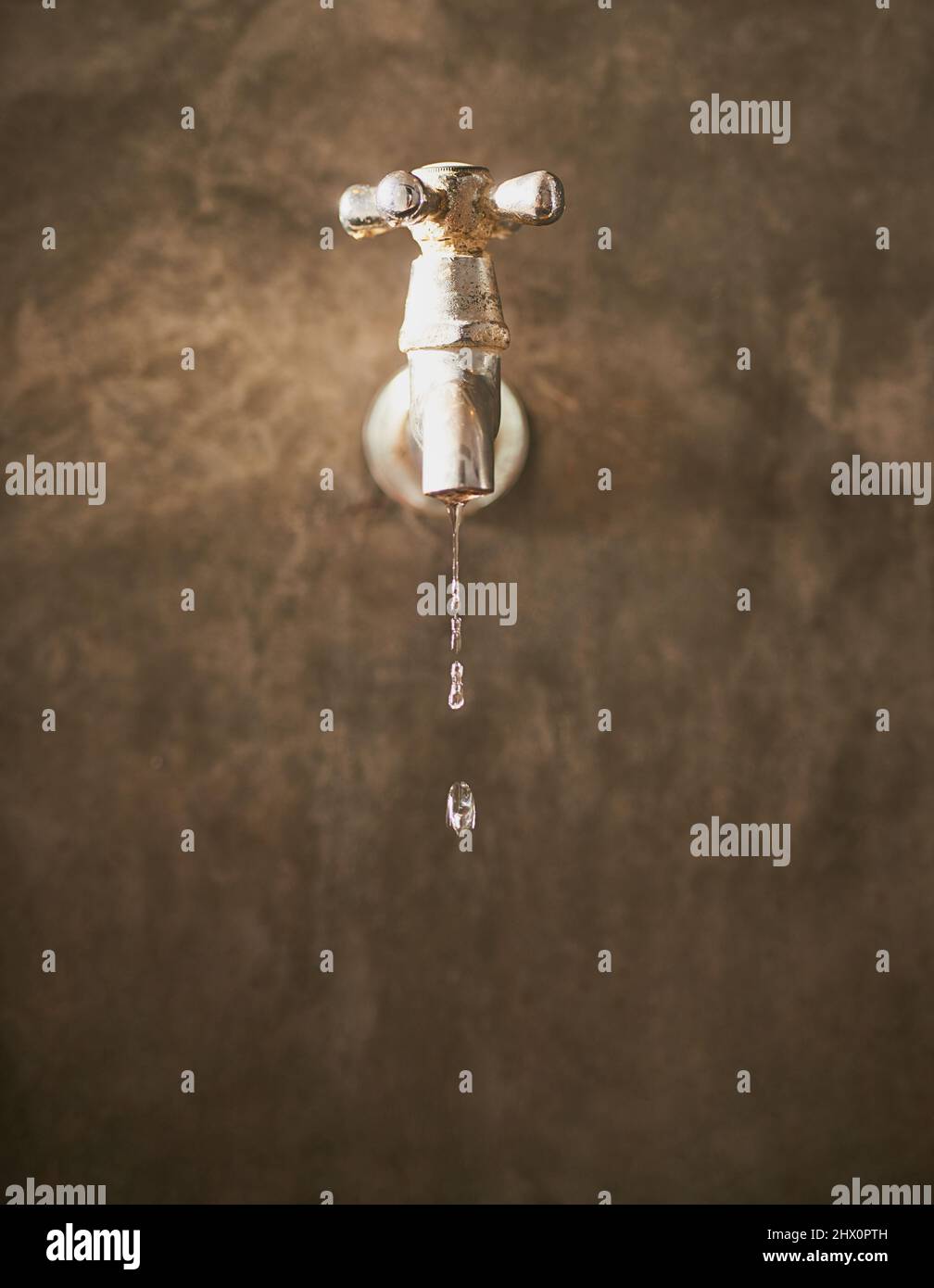 Conserve every drop you can. Cropped closeup shot of a tap dripping ...