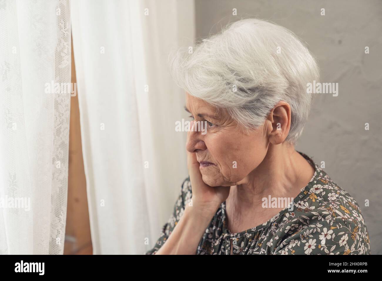 extremely worried and upset grey-haired grandma alone on grandparent's ...