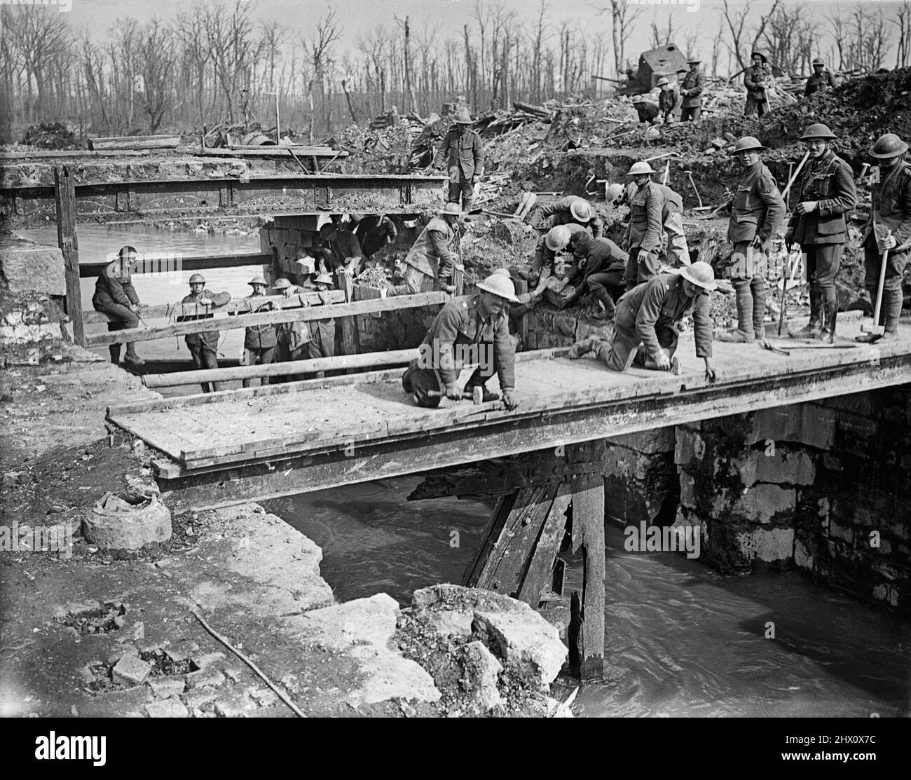 Royal Engineers building a temporary bridge over a wrecked lock at ...