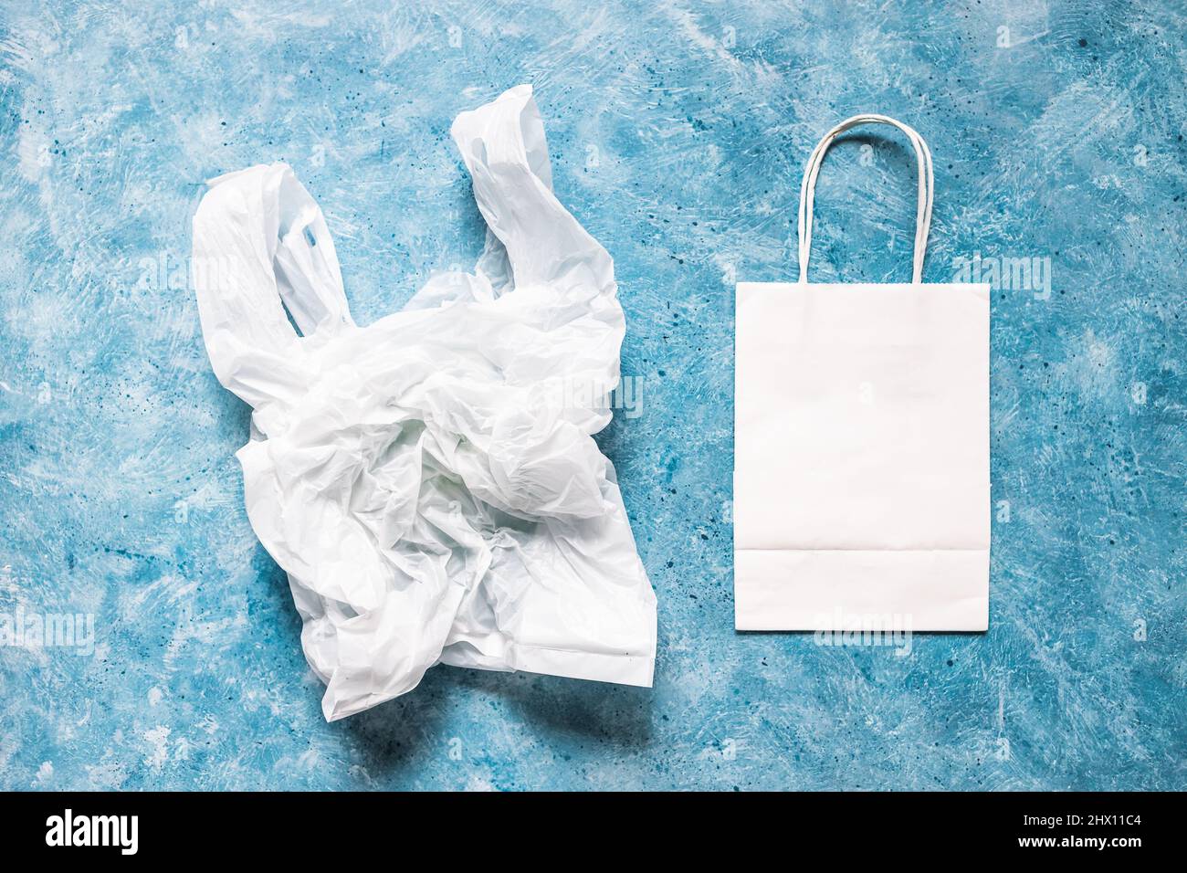 single use plastic bag next to paper one, plastic pollution and ...
