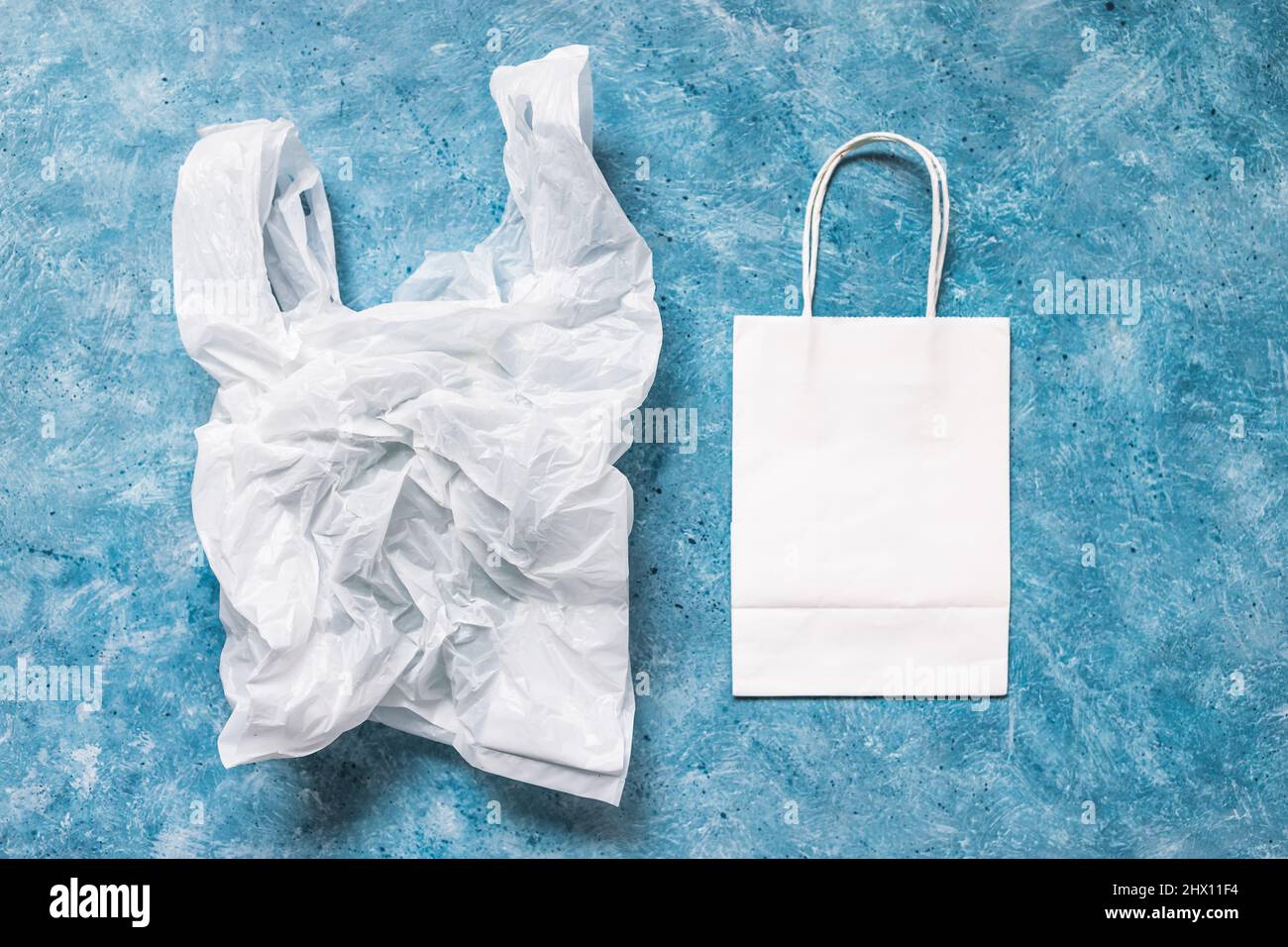 single use plastic bag next to paper one, plastic pollution and ...