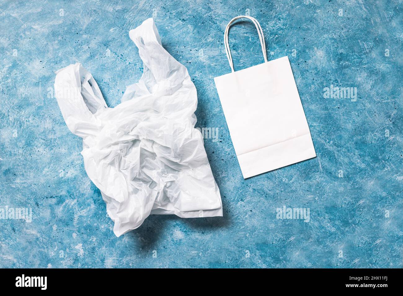 single use plastic bag next to paper one, plastic pollution and ...
