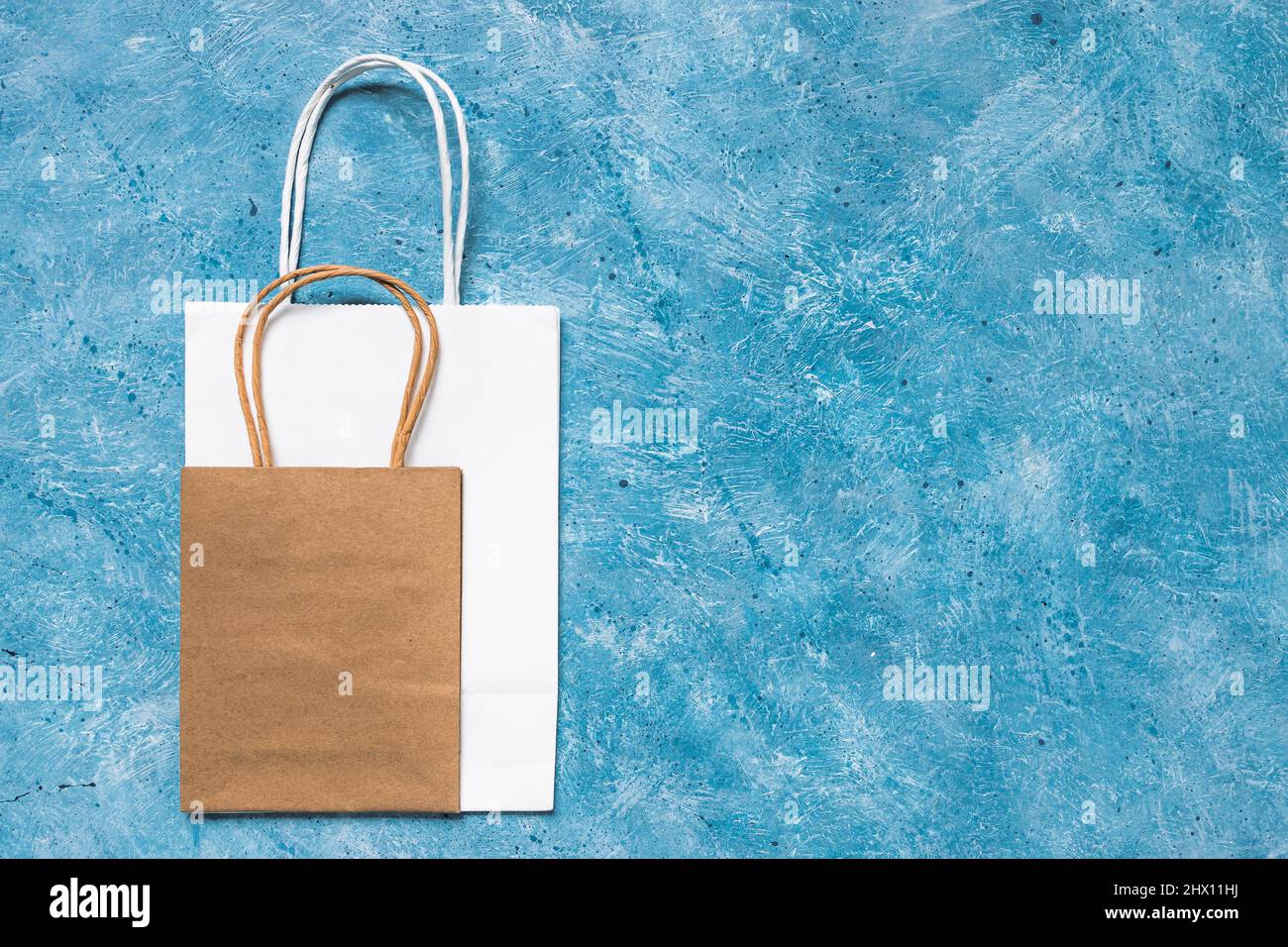 paper shopping bags in different sizes and colours, concept of branding ...