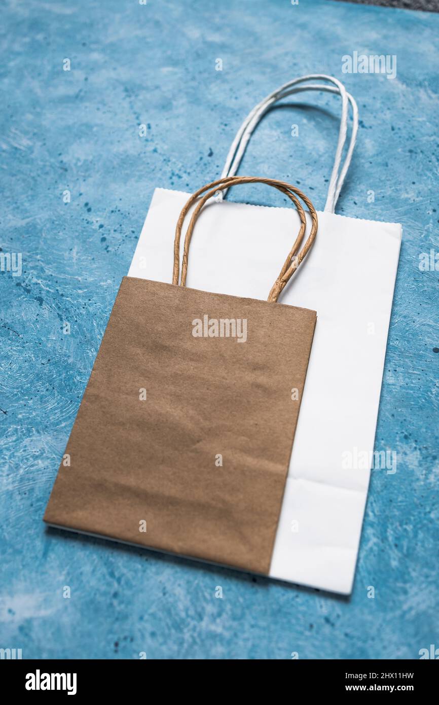 paper shopping bags in different sizes and colours, concept of branding ...
