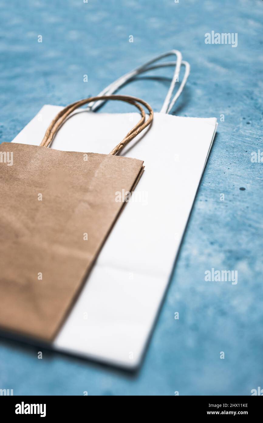 paper shopping bags in different sizes and colours, concept of branding ...
