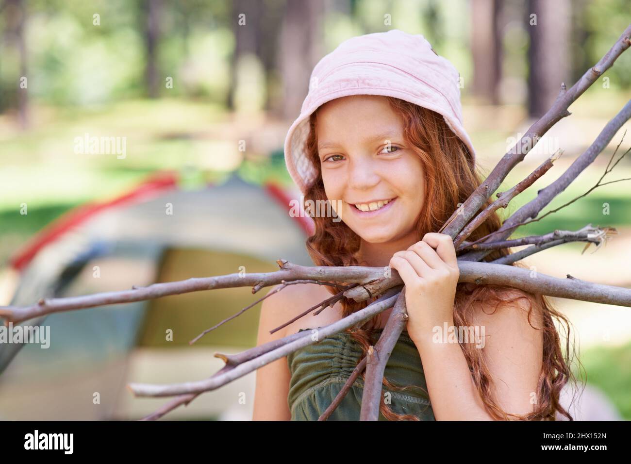 Twigs for our marshmallow smores. Shot of a young girl holding twigs in ...