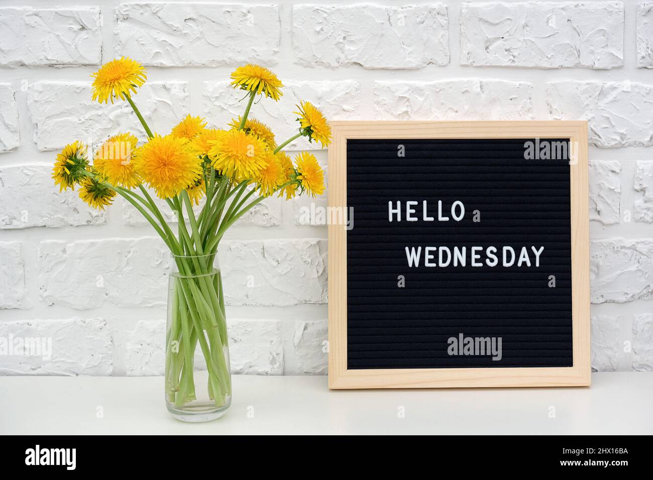 Hello Wednesday words on black letter board and bouquet of yellow ...