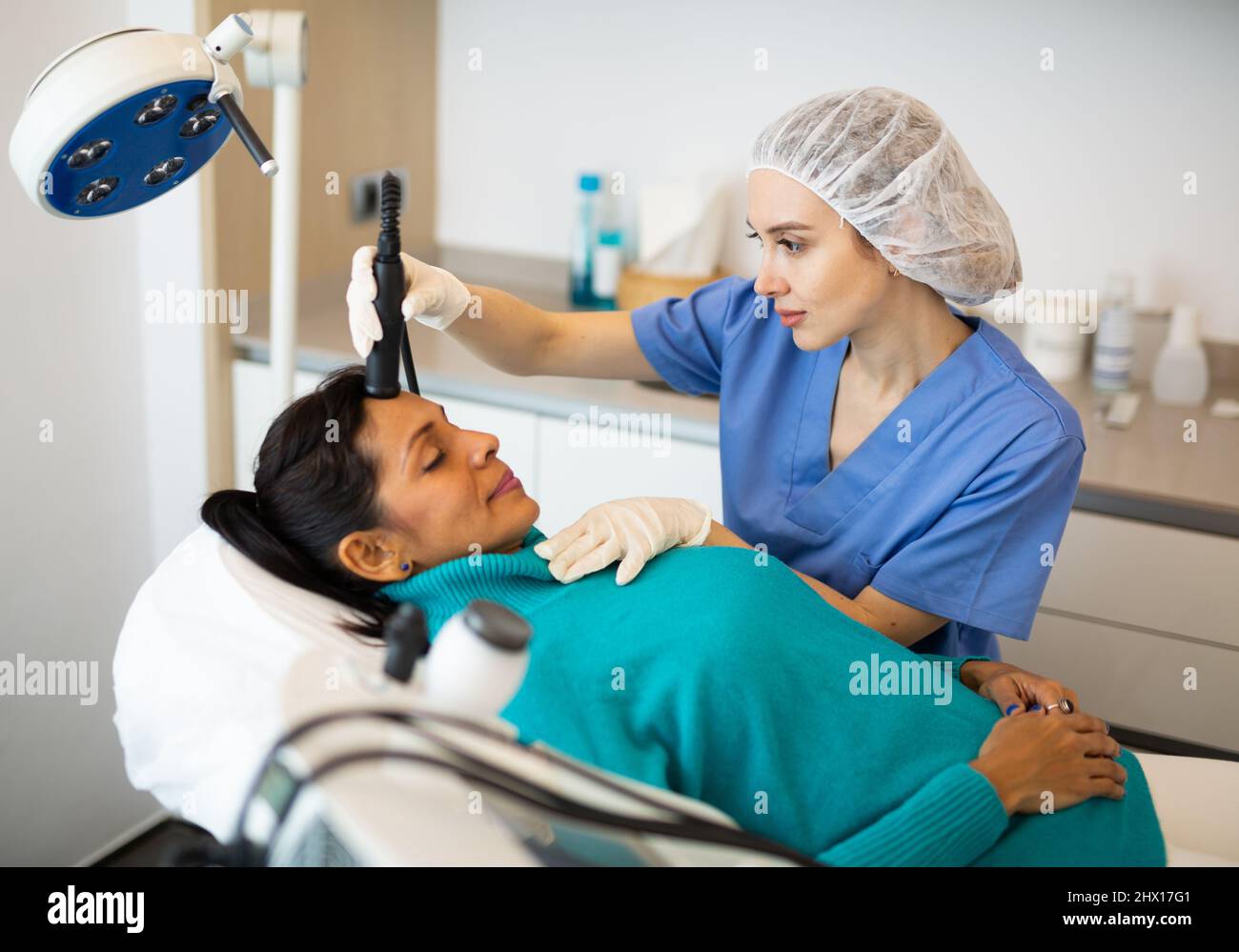Woman receiving face ultrasound lifting procedure Stock Photo - Alamy