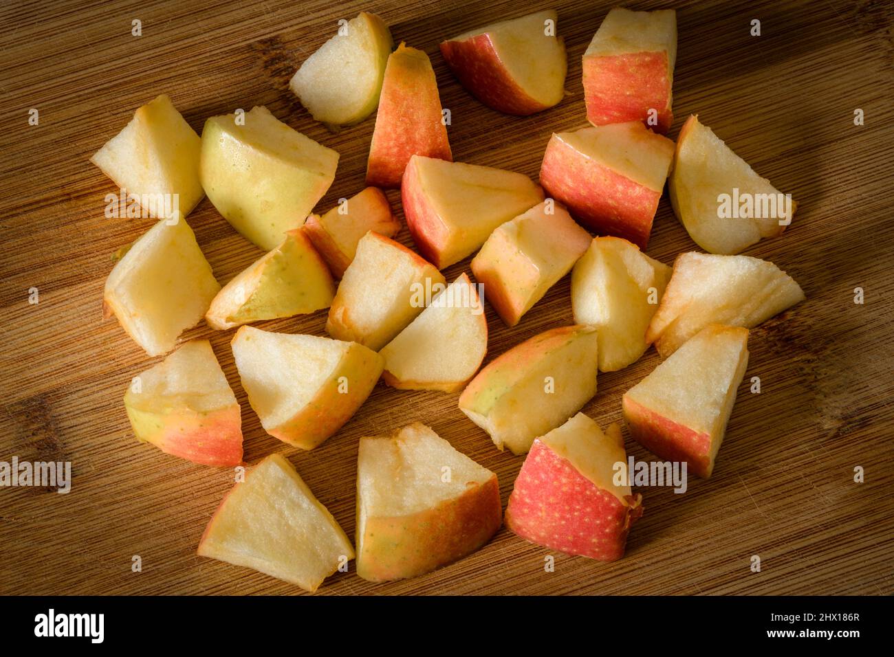 A pile of diced red apple. Pieces of apple sitting on the wooden ...