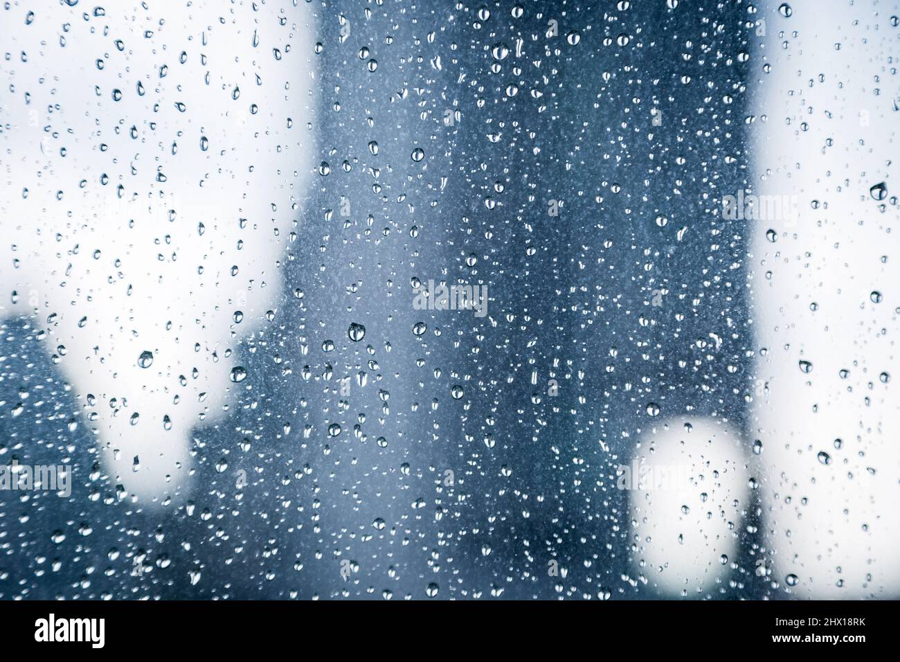 Abstract image of Rain drops on the dirty glass windows with modern ...