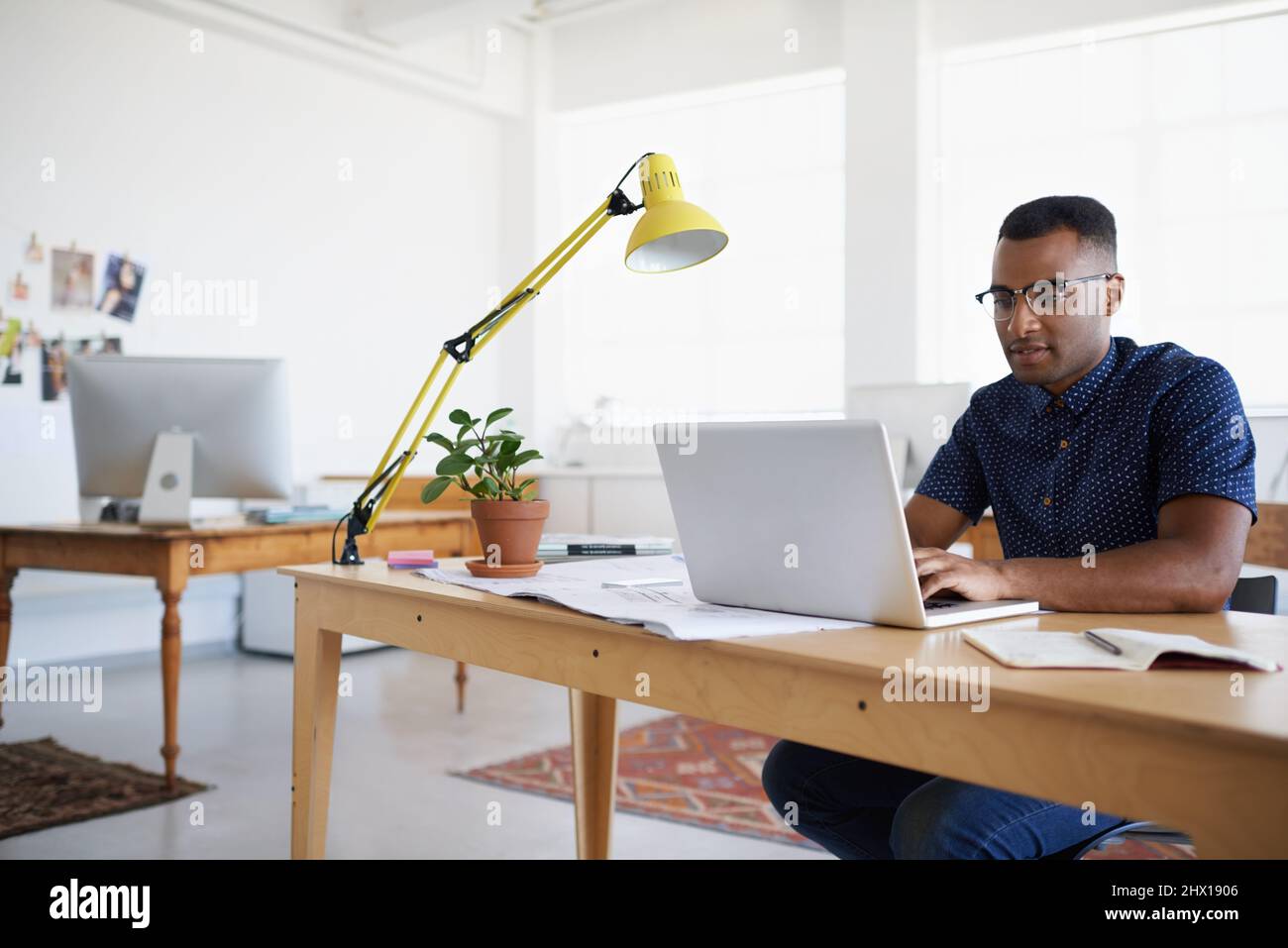 Hard at work. A handsome young man working at his desk Stock Photo - Alamy