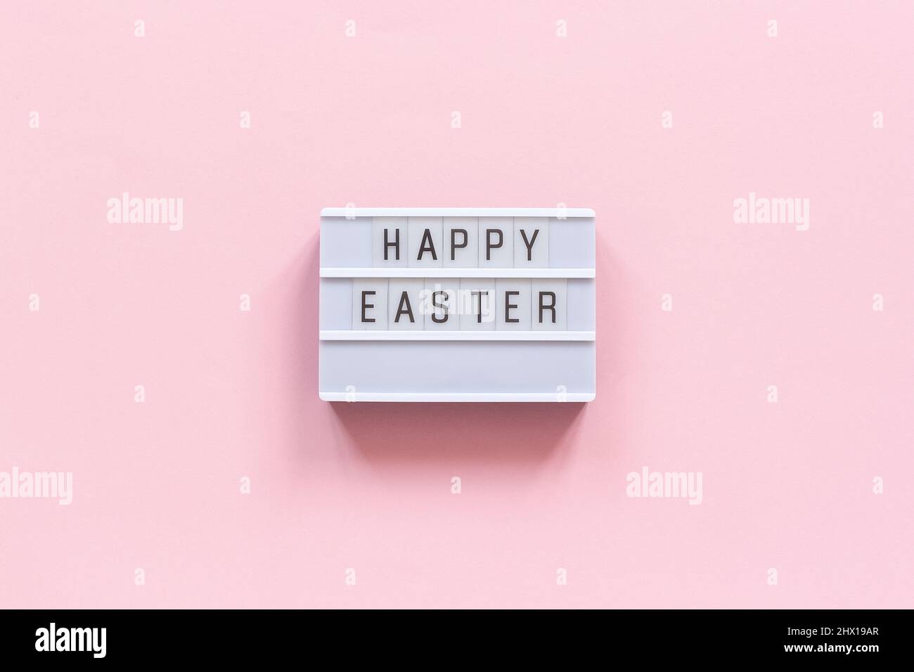 Lightbox text Happy Easter on pink paper background. Concept Easter ...