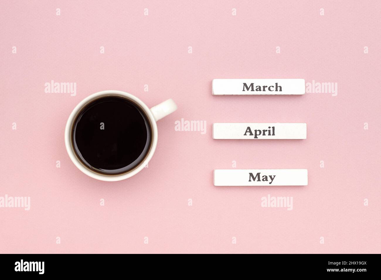 Wooden calendar spring months March April May and Cup of black coffee ...