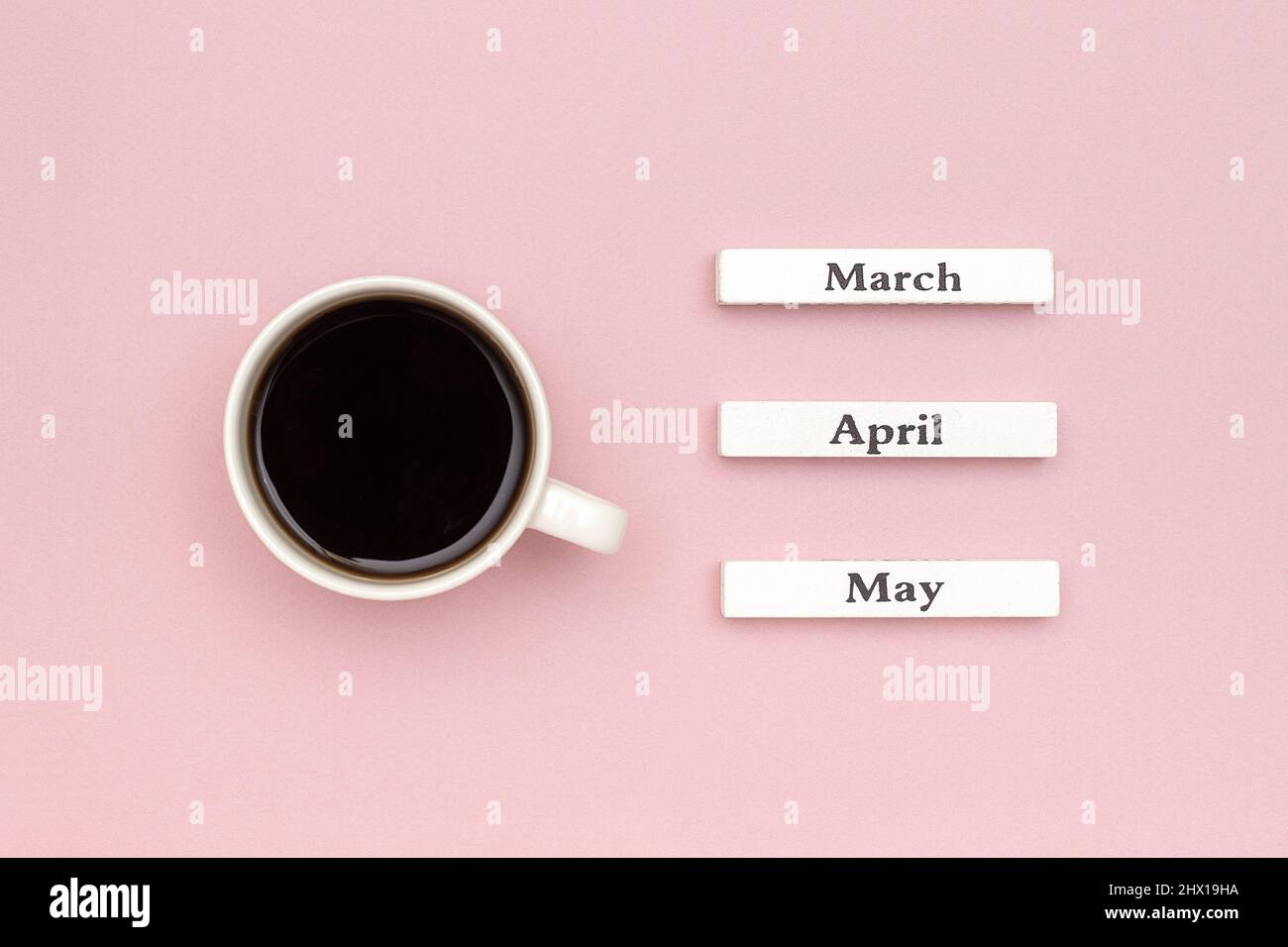 Wooden calendar spring months March April May and Cup of black coffee ...