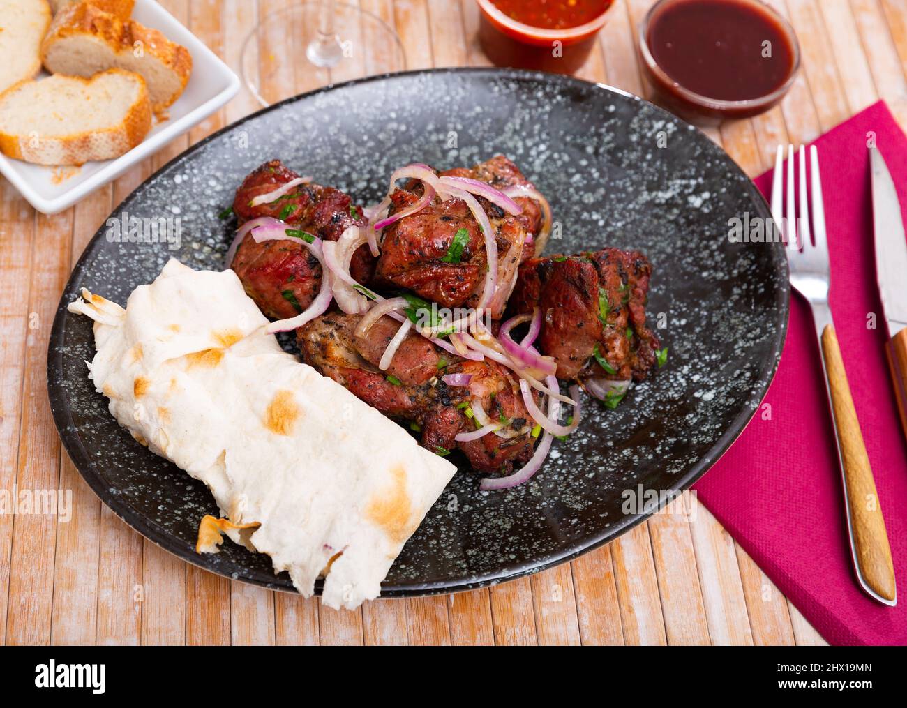 Grilled pork meat shashlik with marinated onion Stock Photo - Alamy