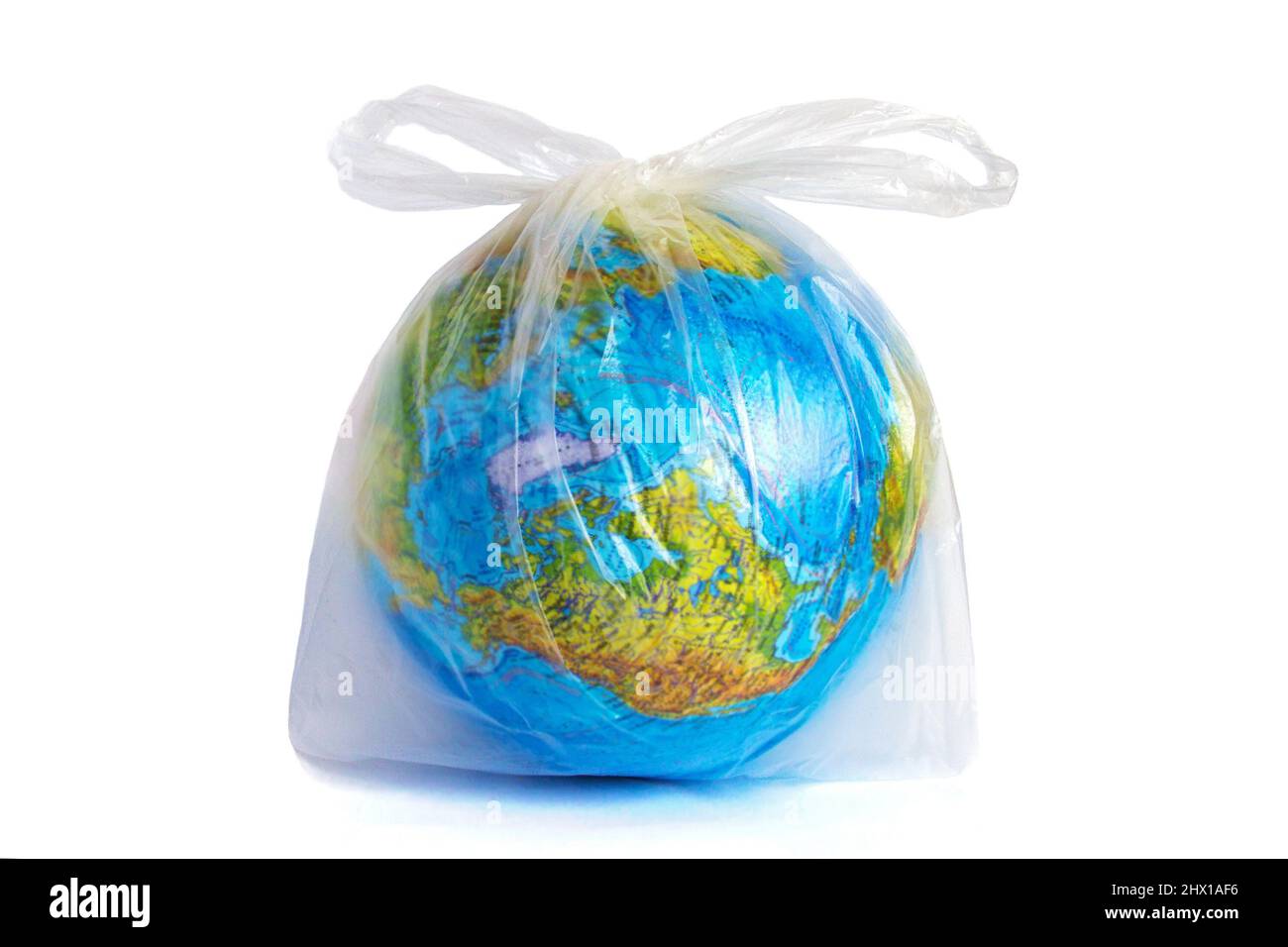 Earth in polyethylene plastic disposable package, isolated on white ...