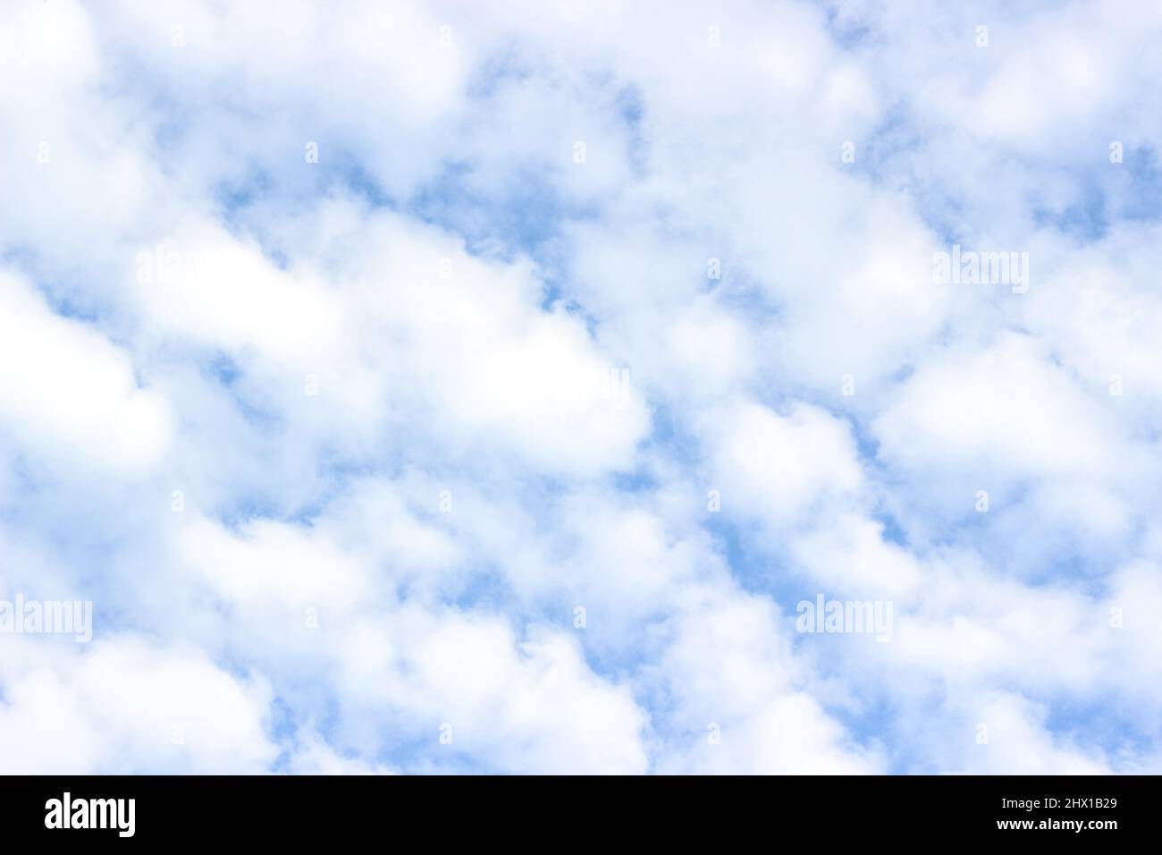 White fluffy cumulus clouds blue sky background texture Stock Photo - Alamy