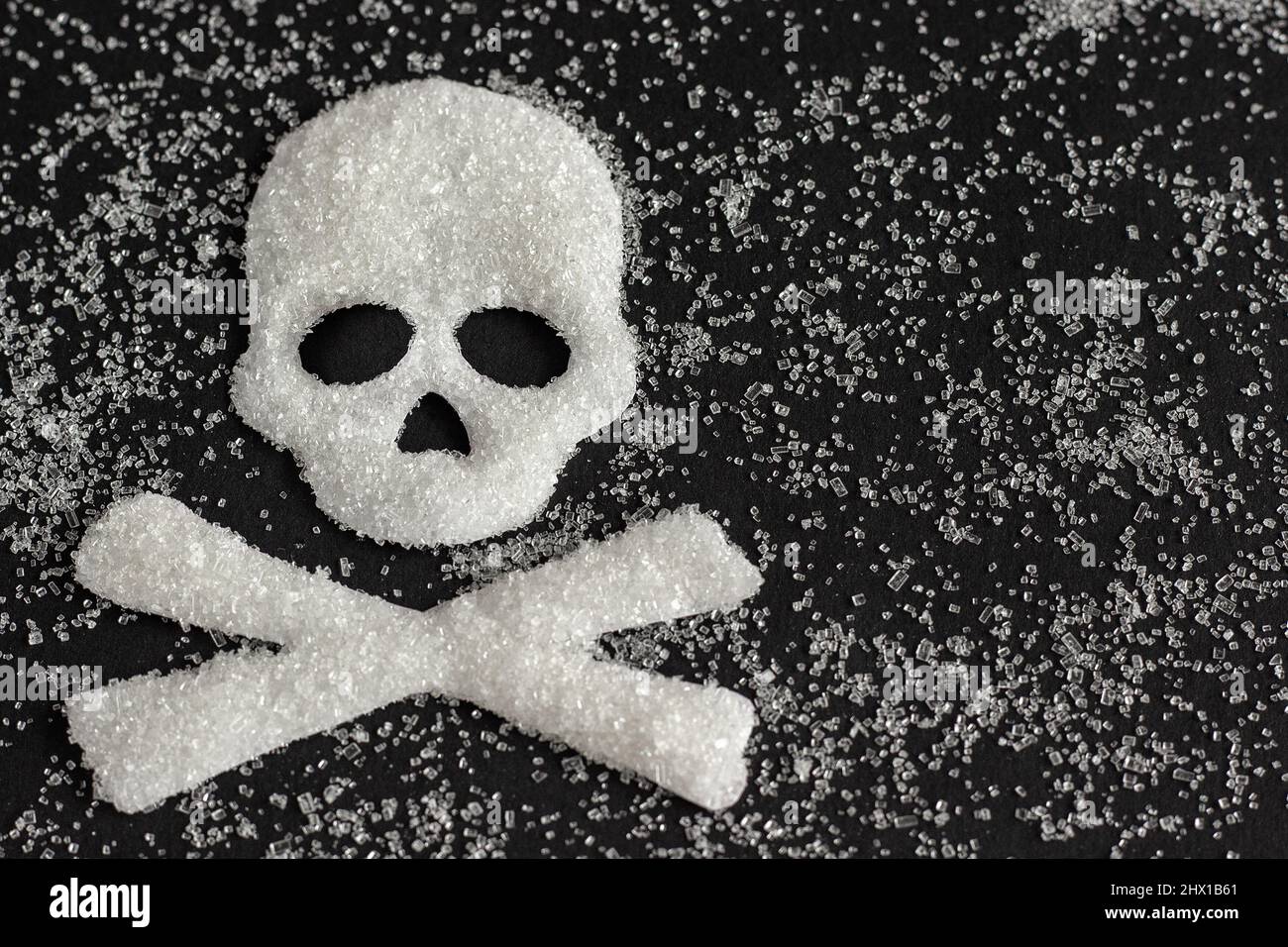 Death symbol with skull shape from sugar on black background, Concept ...
