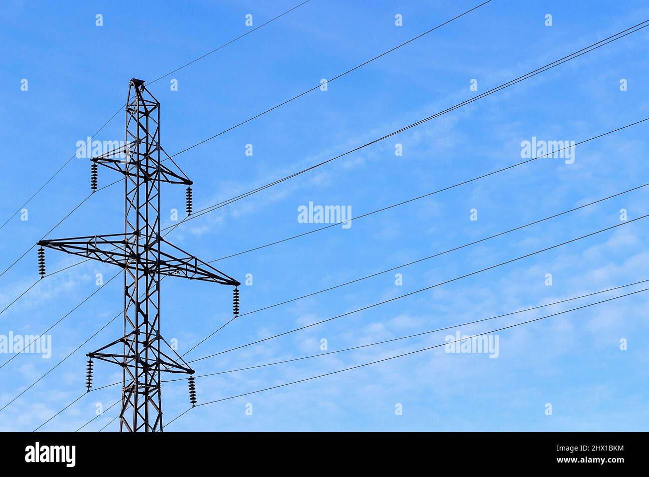 Metal support (elektroopora) of overhead power lines against a blue sky ...