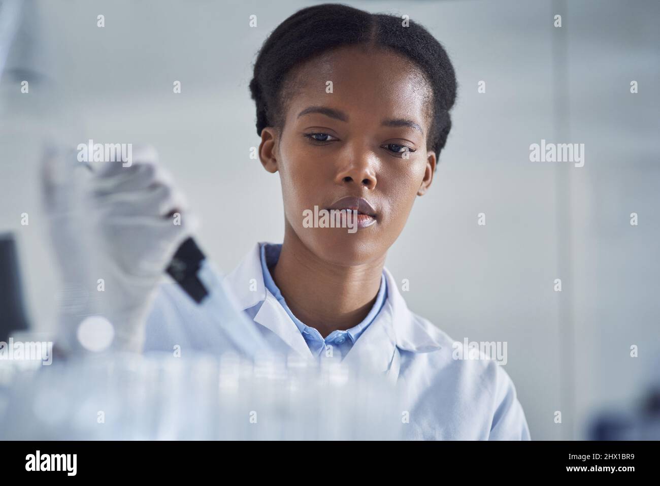 Ensuring the cure is up to standard. Shot of a young scientist working ...