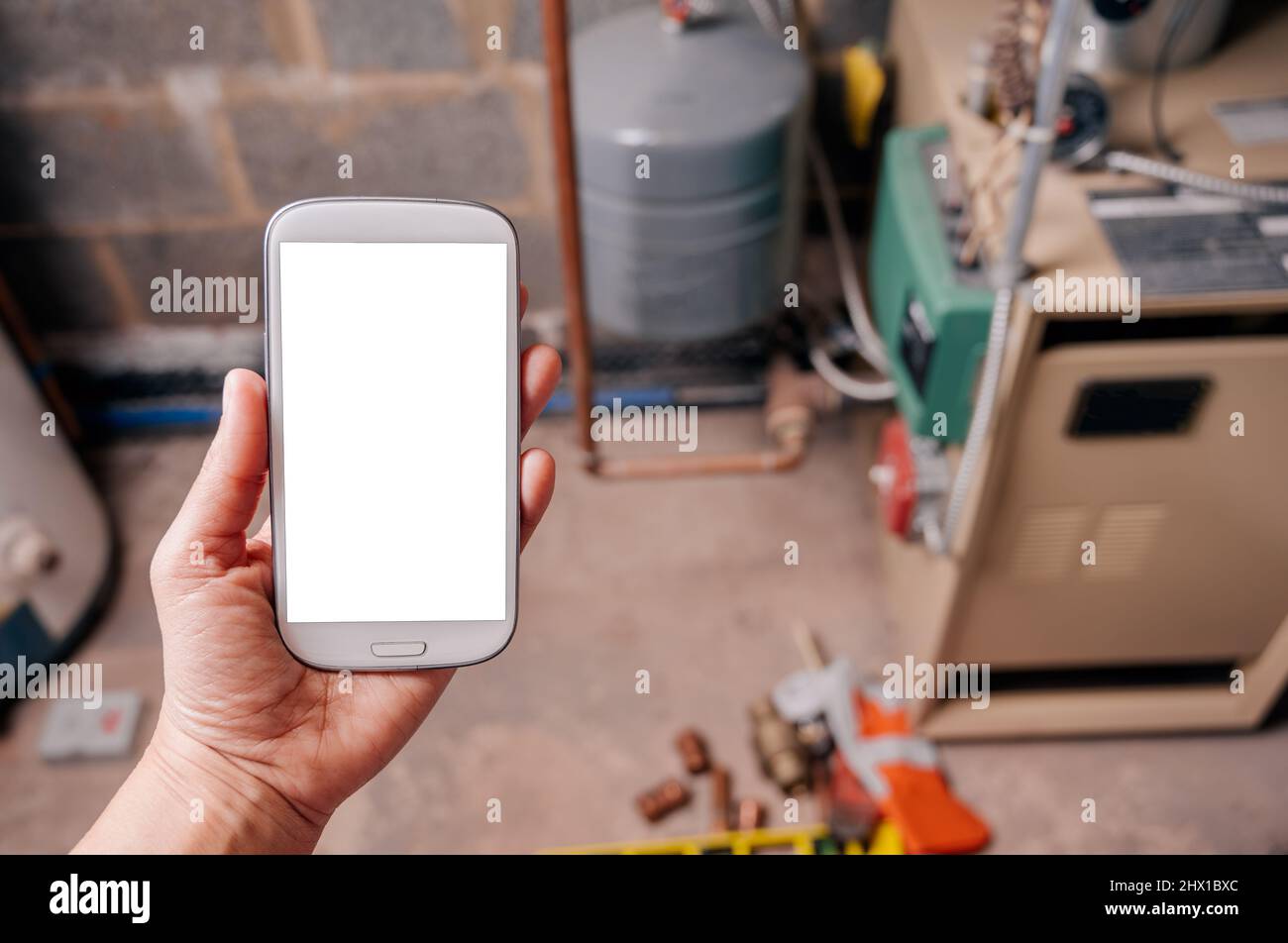 Plumbing smartphone app mock up on Hot-water heater service background ...