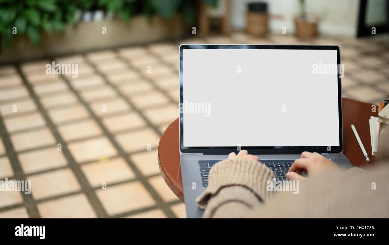 Female college student doing her online homework on laptop computer at ...