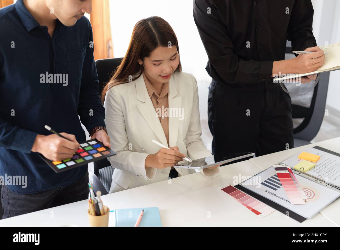 A group of creative interior designers are working together, discussing ...