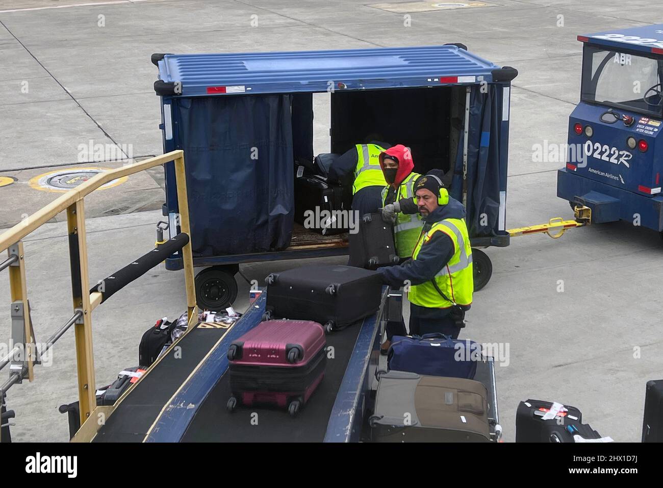 American Airlines baggage handlers load luggage on an airplane at the O ...