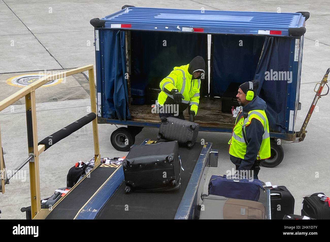 American Airlines baggage handlers load luggage on an airplane at the O ...