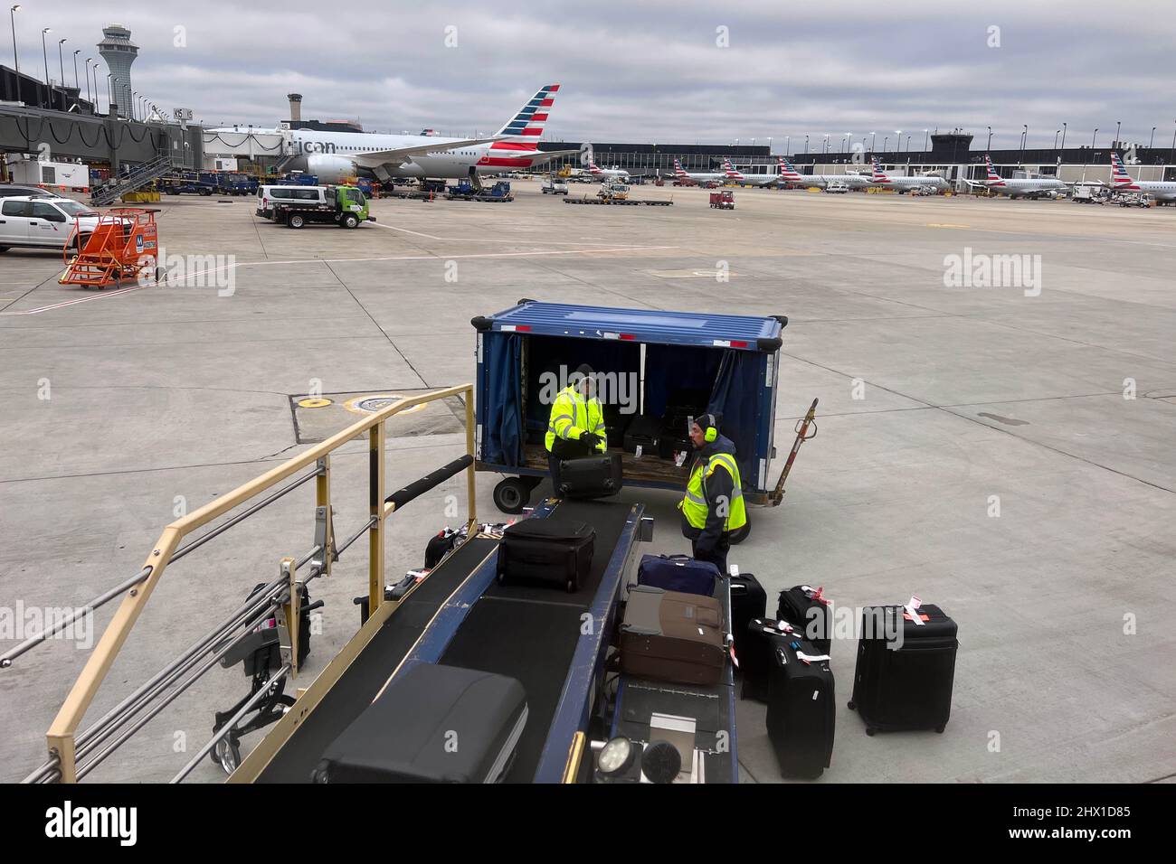 American Airlines baggage handlers load luggage on an airplane at the O ...