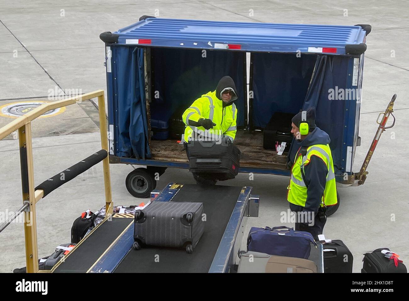 American Airlines baggage handlers load luggage on an airplane at the O ...
