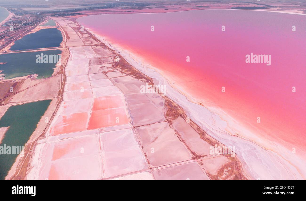 Flying over a pink salt lake. Salt production facilities saline ...