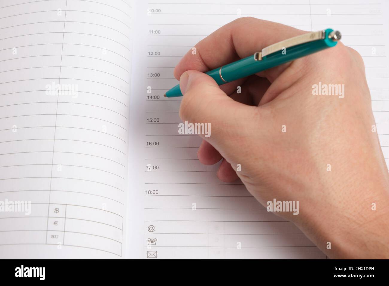 Hand with green ballpoint pen background white notepad sheets.Notes and ...